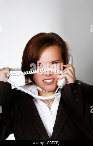 portairt of woman with telephone cord wrapped around face Stock Photo ...