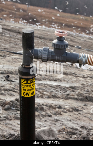 A vertical landfill methane gas wellhead and valve at an active ...