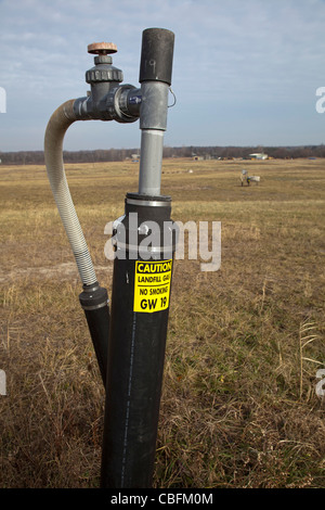 A vertical landfill methane gas wellhead and valve at an active ...