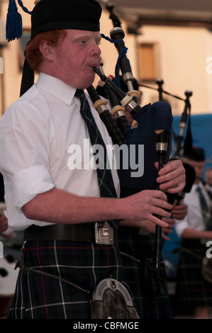 Side view of a traditional Scottish musician playing the bagpipes ...