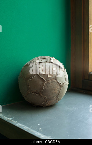 Torn up old soccer ball lay on grass. Worn out football. Concept of ...