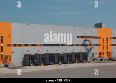 Warehouse with loading docks outdoors. Logistics center Stock Photo - Alamy