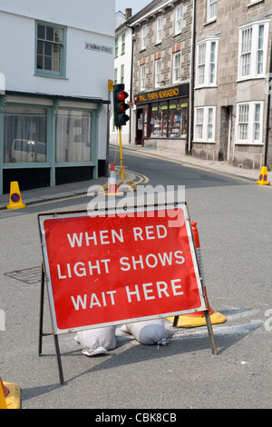When red light shows wait here sign at traffic lights for road works ...
