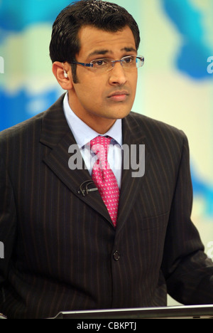 Al Jazeera English anchor delivering the news at the Doha HQ of AJE ...