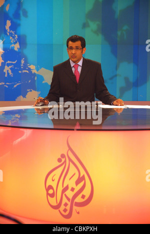 Al Jazeera English anchor delivering the news at the Doha HQ of AJE ...