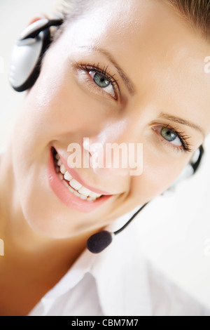 a young switchboard operator smiling at the camera on white background ...