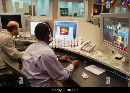 Al Jazeera Television newsroom with reporters and editors researching ...
