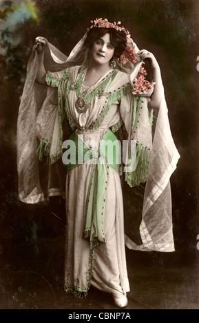 Woman in a fringed shawl and flower hair accessory walking during ...