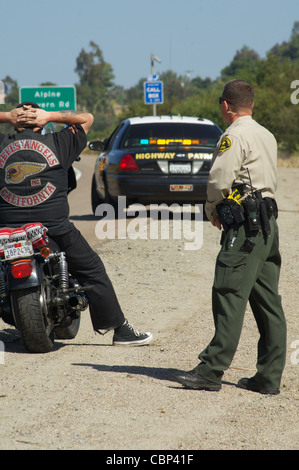 A sheriff's deputy from the San Diego sheriff's department secures a ...