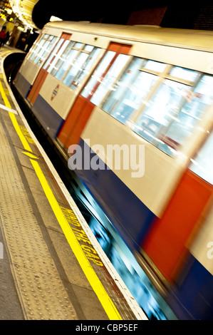 Tube train moving through Station Stock Photo - Alamy