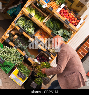 People buying fruit and veg from a stall in Portsmouth street market ...