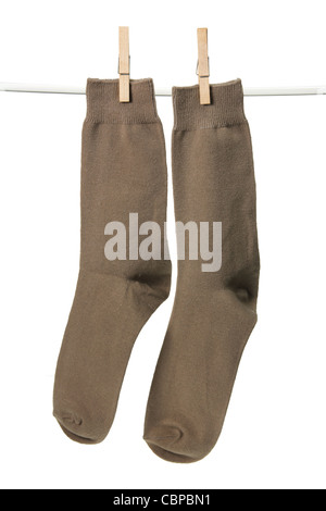 Pair of socks hanging on washing line against light grey background ...