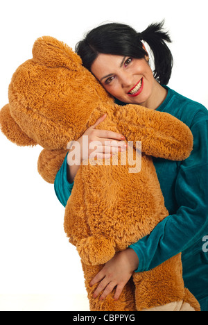 Young woman wearing pyjama hugging pillow smiling amazed and surprised ...