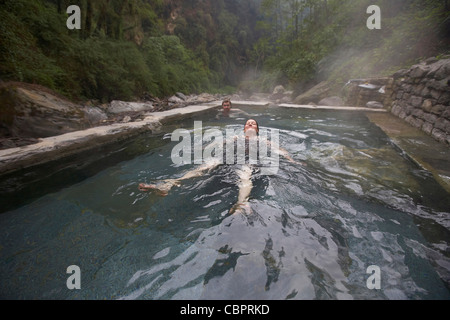 Trekkers relaxing at hot springs. Tatopani village. Annapurna circuit ...