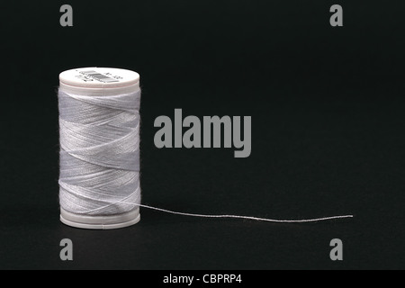White thread roll on the spindle Stock Photo - Alamy
