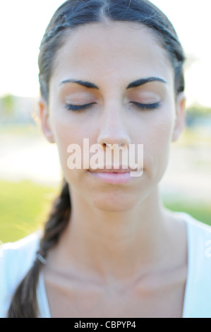 Portait of young woman in grass Stock Photo - Alamy