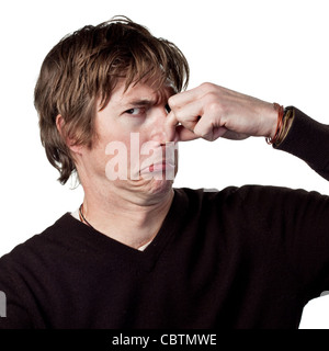 Man covers nose due to bad smell Stock Photo - Alamy