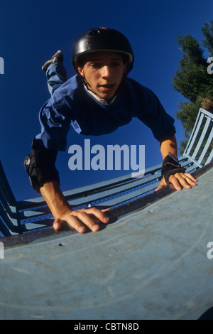 Teenage boy inline skating on the vert ramp Stock Photo - Alamy