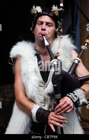 Man busking dressed in Scottish Soldier Outfit sitting by his armor and ...