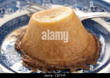 A serving plate with a steak and kidney suet pudding, boiled new ...