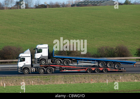 Back view Trucks Lorries & articulated flat bed trailers overtaking ...