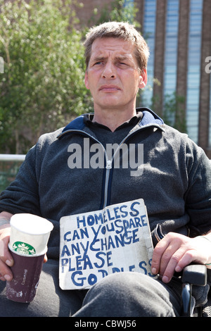 Homeless amputee in a wheelchair begging for money Stock Photo - Alamy