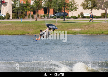 Man jumping the wake, stunts on a wakeboard, extreme sport Stock Photo ...