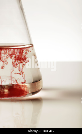 Beaker with red dye Stock Photo - Alamy