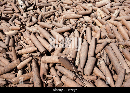 Artillery and mortar shells lie rusting in the sun in a scrap yard in ...
