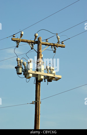 Power lines against blue sky Stock Photo - Alamy