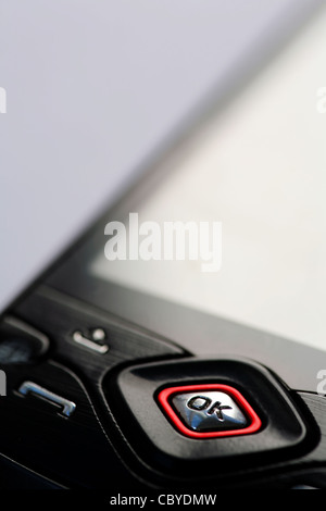 Close up shot of a mobile phone with broken screen on a wooden table ...