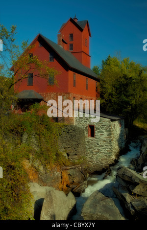 A serene scene of an old mill stream, with its calm waters flowing past a rustic mill. The image ...