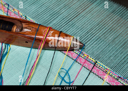 Weaving loom and shuttle on the warp. Weaving background and sample ...