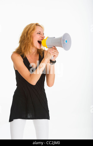 Young caucasian woman yelling through megaphone over isolated ...