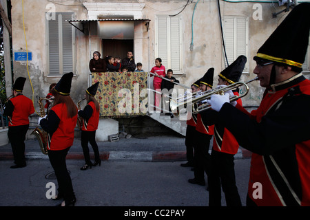 An Israeli Arab Christian marching band pass by a Muslim family during ...