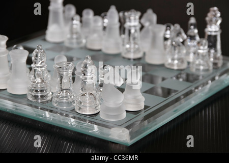 Chess game with glass transparent chess on translucent chessboard. King ...