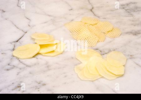 Kitchen: Cut Potatoes Into Slices. Potatoes Gaufrettes Stock Photo - Alamy
