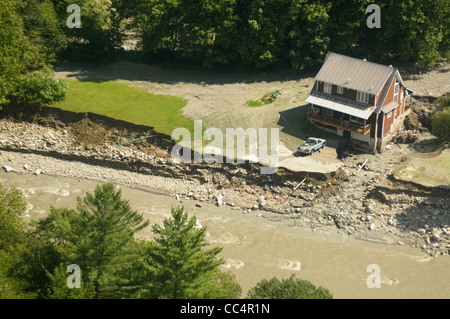 A road is shown damaged by flood water caused by tropical storm Irene ...