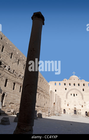 A vertical shot of the ancient columns with Egyptian carvings in Karnak ...