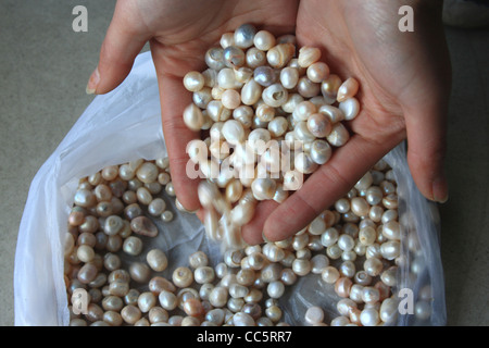 People holding pearls in both hands Stock Photo - Alamy