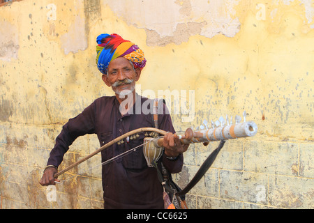 Tribal musician playing a traditional musical instrument, Nagada. Uraov ...
