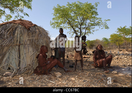 Himba villagers near the Kunene River, the border between Angola and ...