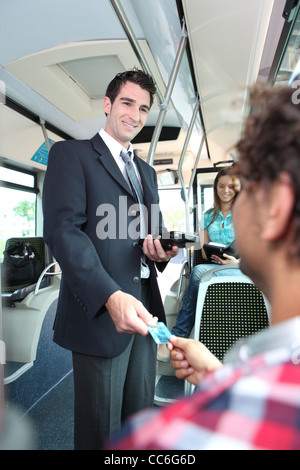 Smiling conductor checking tickets on a tram Stock Photo - Alamy