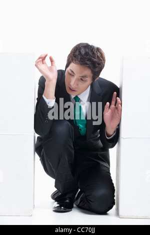 A man stuck between the piled boxes Stock Photo - Alamy