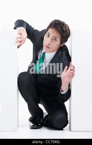 A man stuck between the piled boxes Stock Photo - Alamy