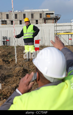 Couple on construction site checking building progress Stock Photo - Alamy