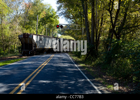 Cargo train crossing a street Stock Photo - Alamy