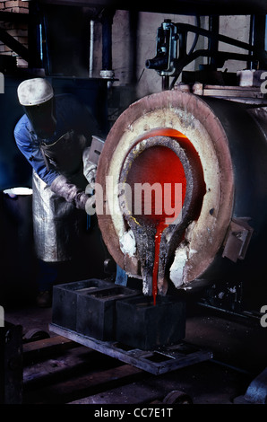 Pouring Molten Gold into a bar mold, inside of the smelter of the Round ...