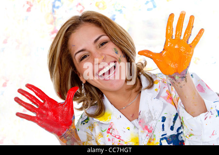 Messy Hispanic woman finger painting Stock Photo - Alamy