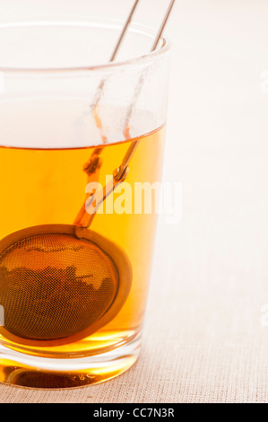 Glass with tea strainer inside, close-up Stock Photo - Alamy